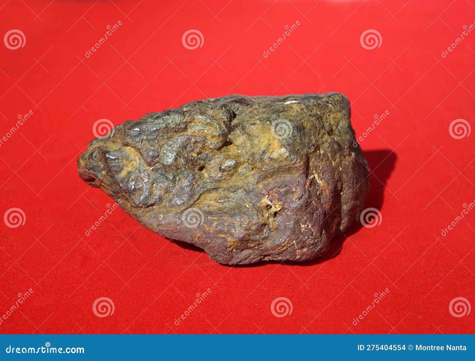 Raw Hematite Mineral Stone on a Red Background in the Museum. Stock ...