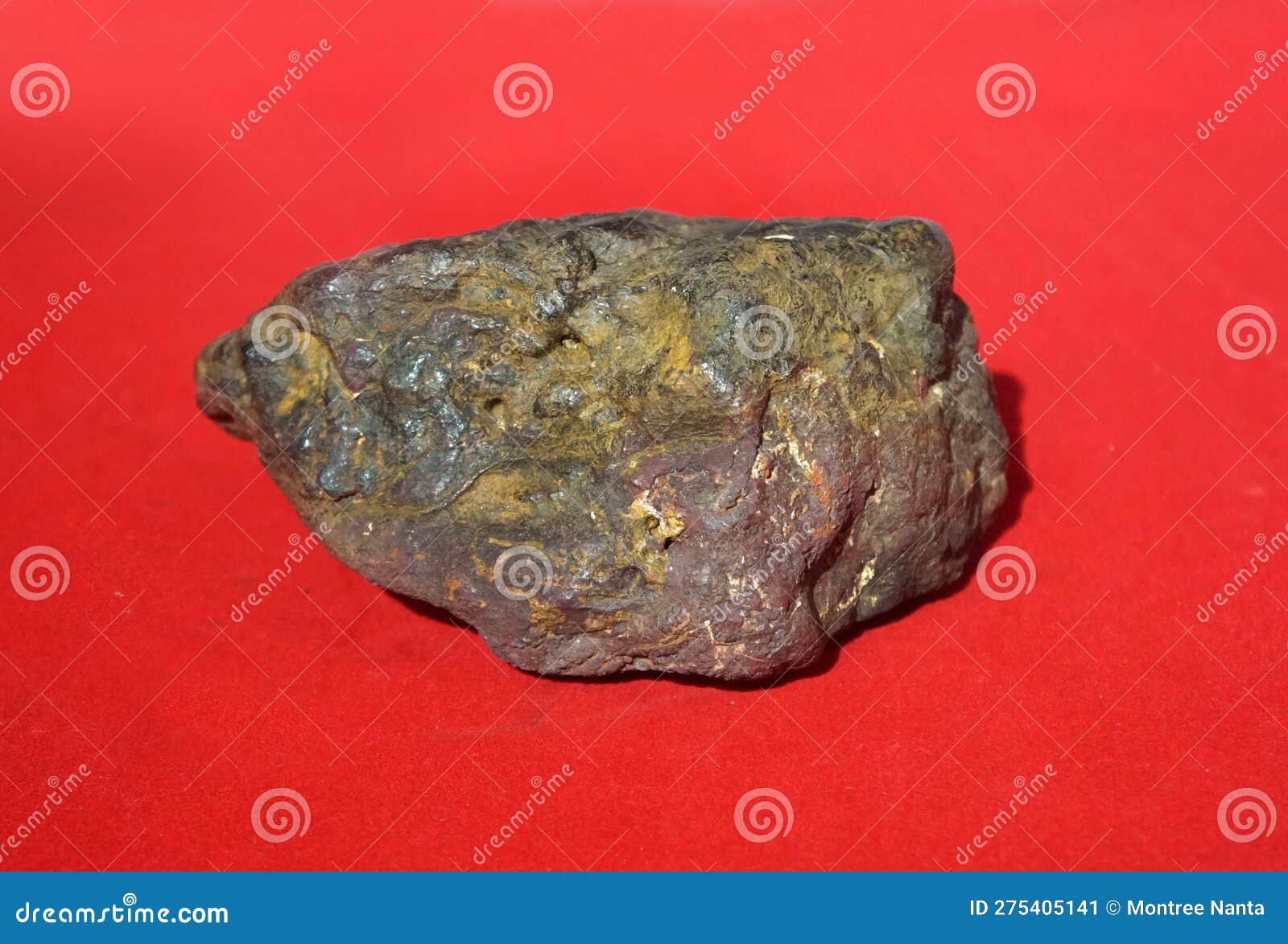 Raw Hematite Mineral Stone on a Red Background in the Museum. Stock ...