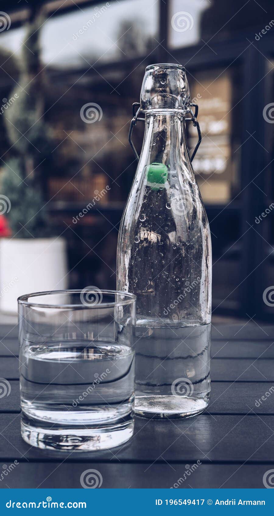 Mineral Water in a Glass on the Table,a Glass Bottle with Ordinary ...