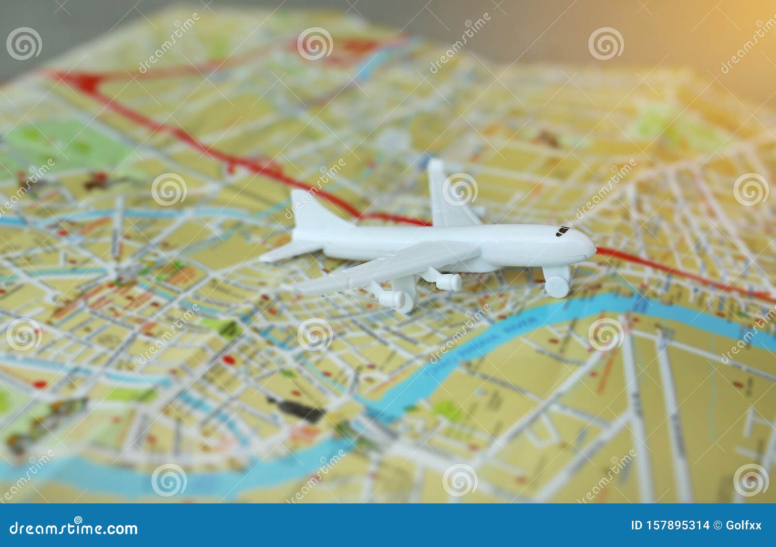 Mini Airplane Model on a Map with Rays of Sunlight, World Travel ...