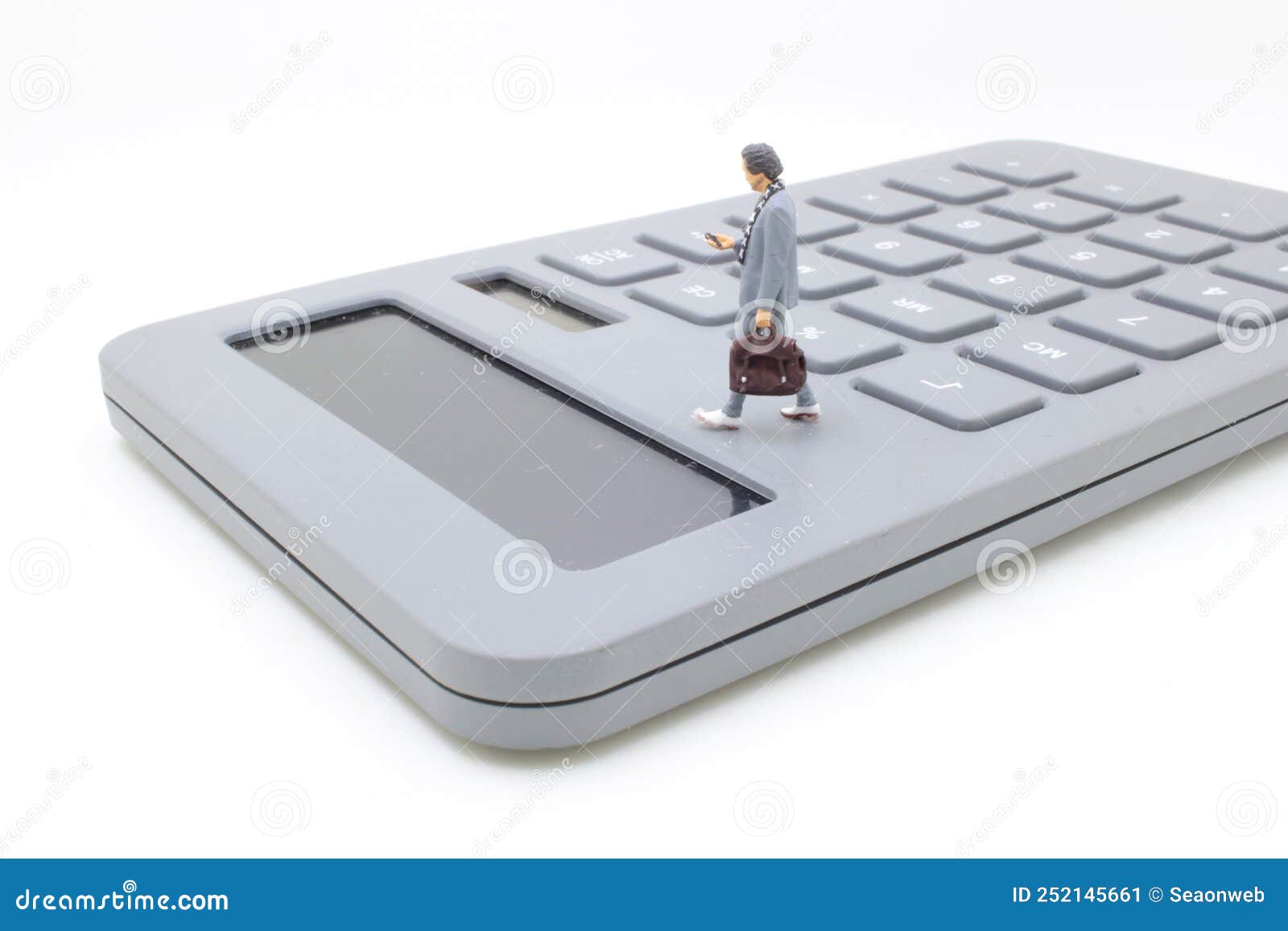 A Mini of Businessmen Standing on Calculator Stock Image - Image of ...