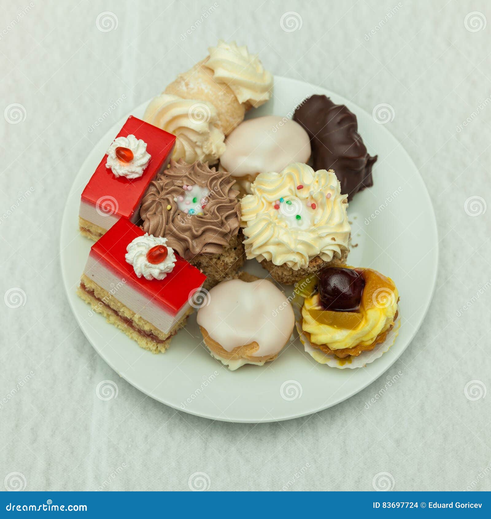 Mini Cakes on a White Plate on the Festive Table Setting Stock Photo ...