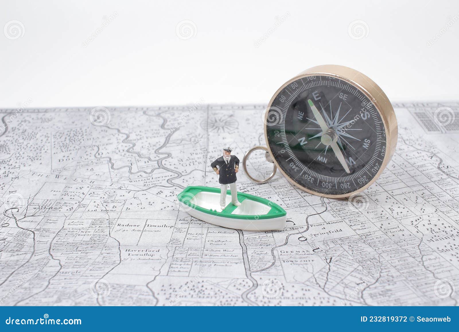 A Mini of Captain on the Boat with Compass and Map Stock Photo - Image ...