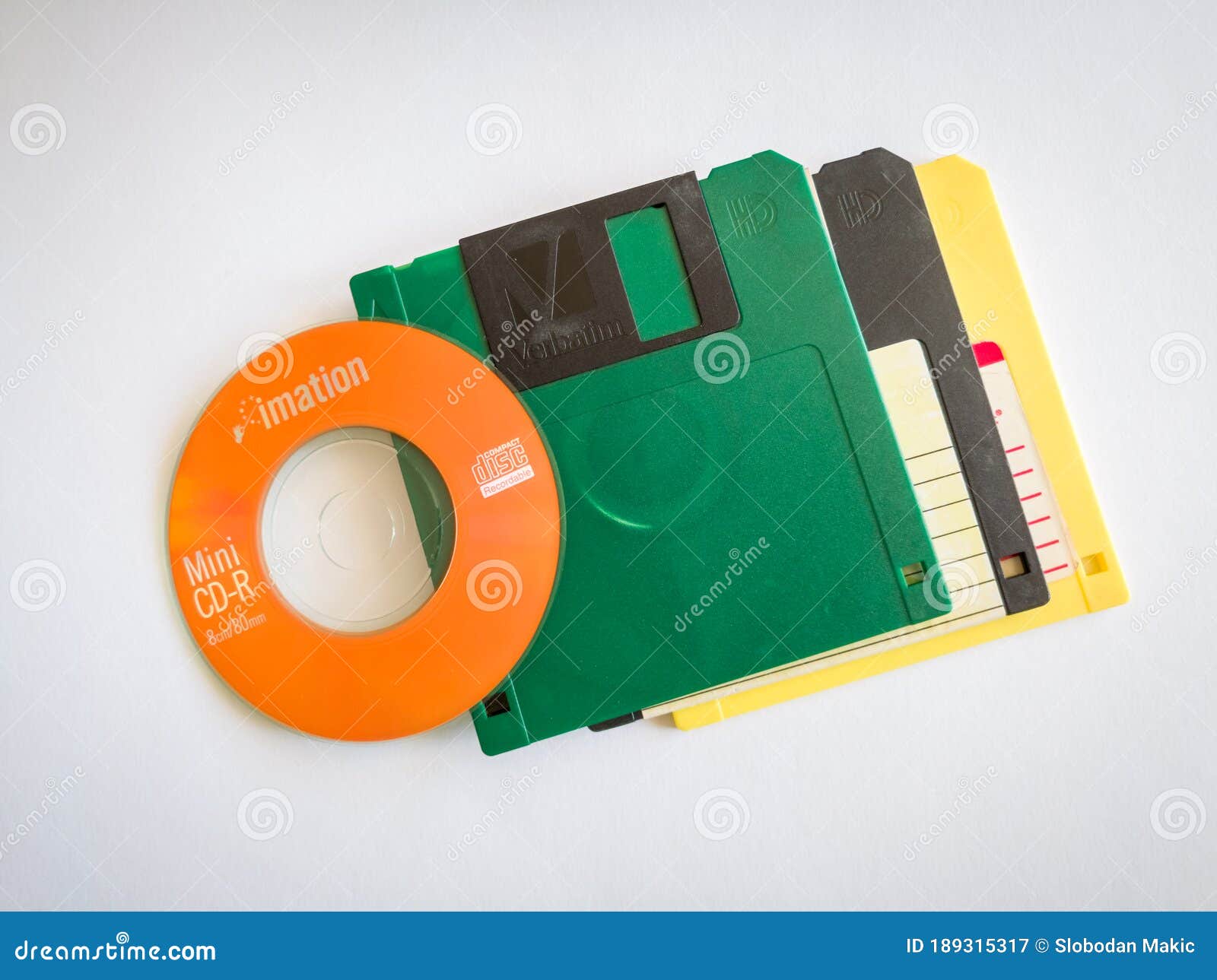 Mini CDs Stacked on Floppy Disks, Objects Isolated on a White ...
