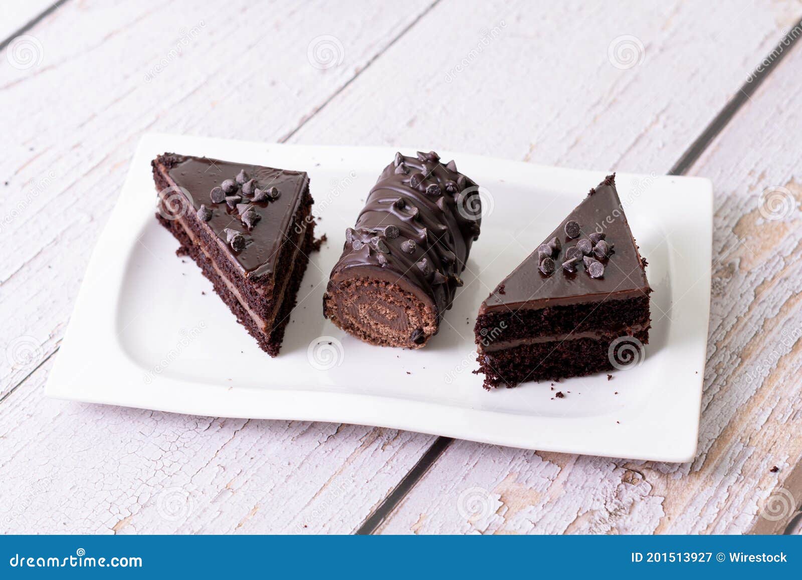 A Mini Chocolate Cake Roll with Two Triangle Chocolate Cake Slices on ...