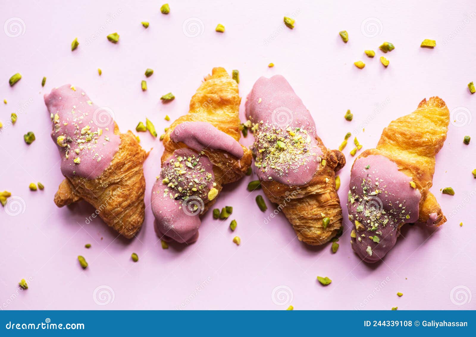 Mini-croissants with Ruby Chocolate and Pistachios on a Pink Background ...