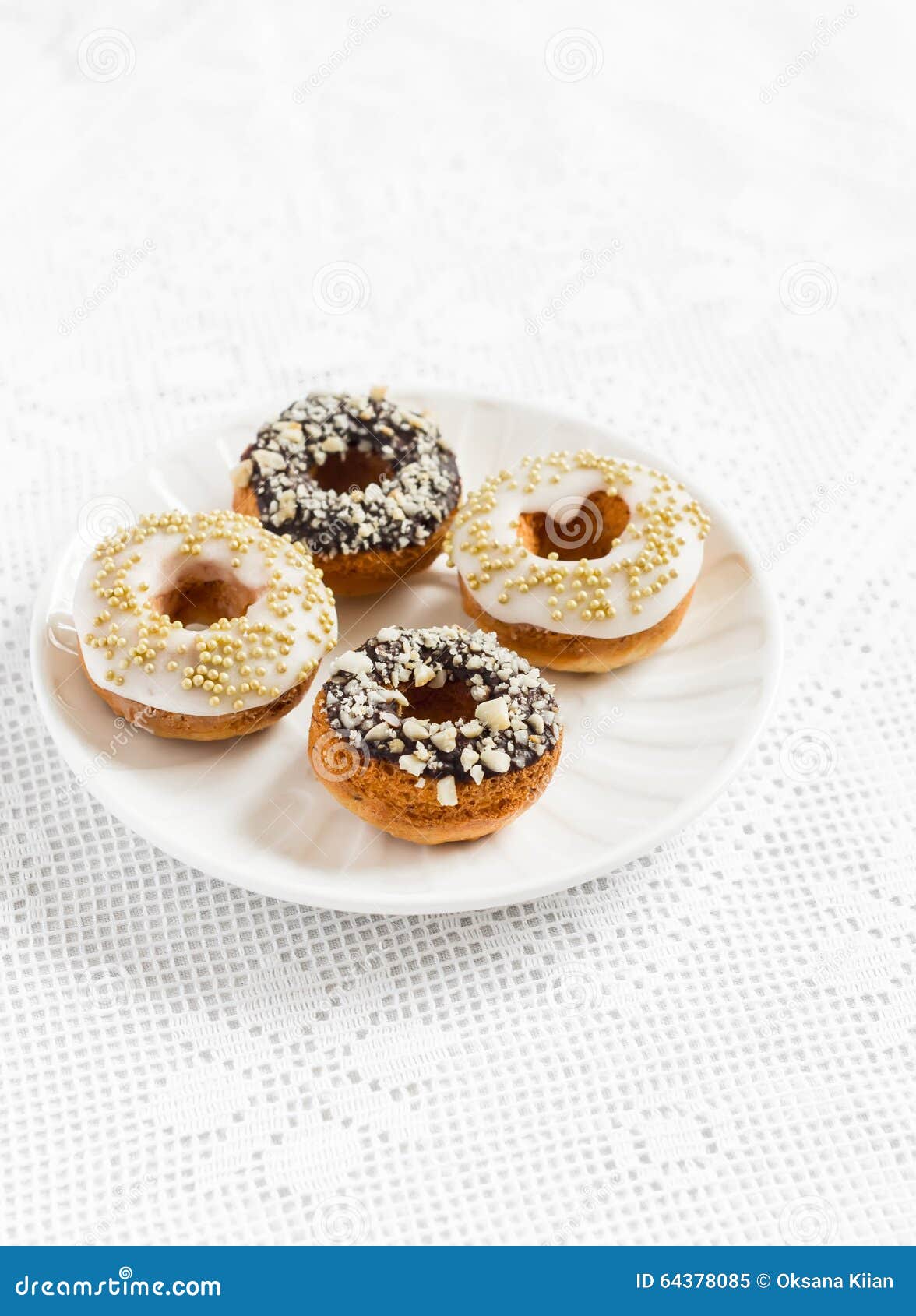 Mini Donuts with Lemon and Chocolate Icing on a White Plate on Bright ...
