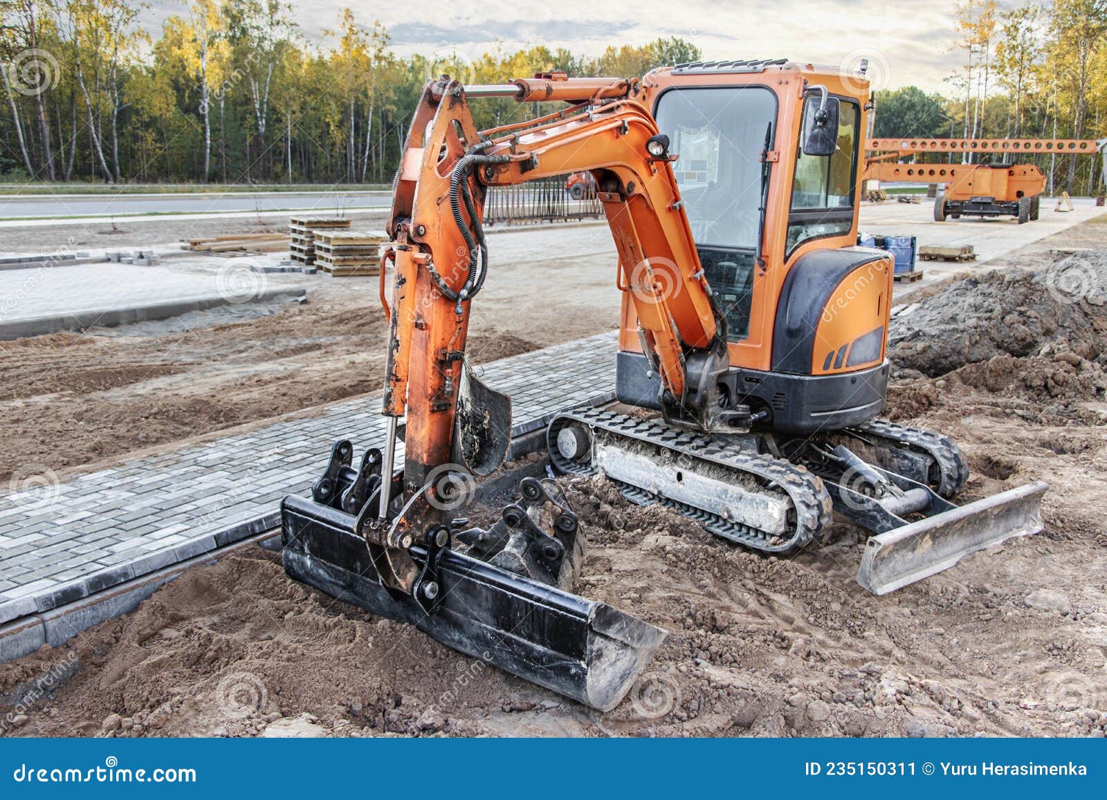 Mini Excavator at the Construction Site. Compact Construction Equipment ...