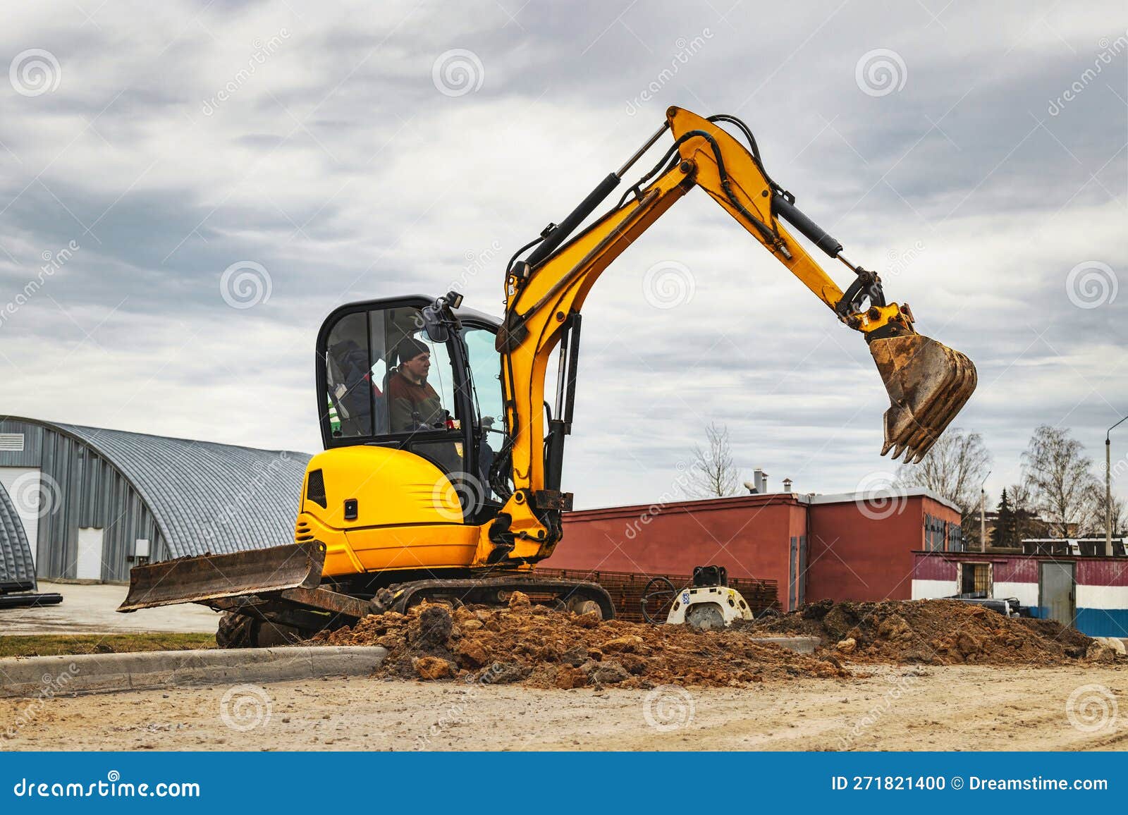 Mini Excavator at the Construction Site. Compact Construction Equipment ...