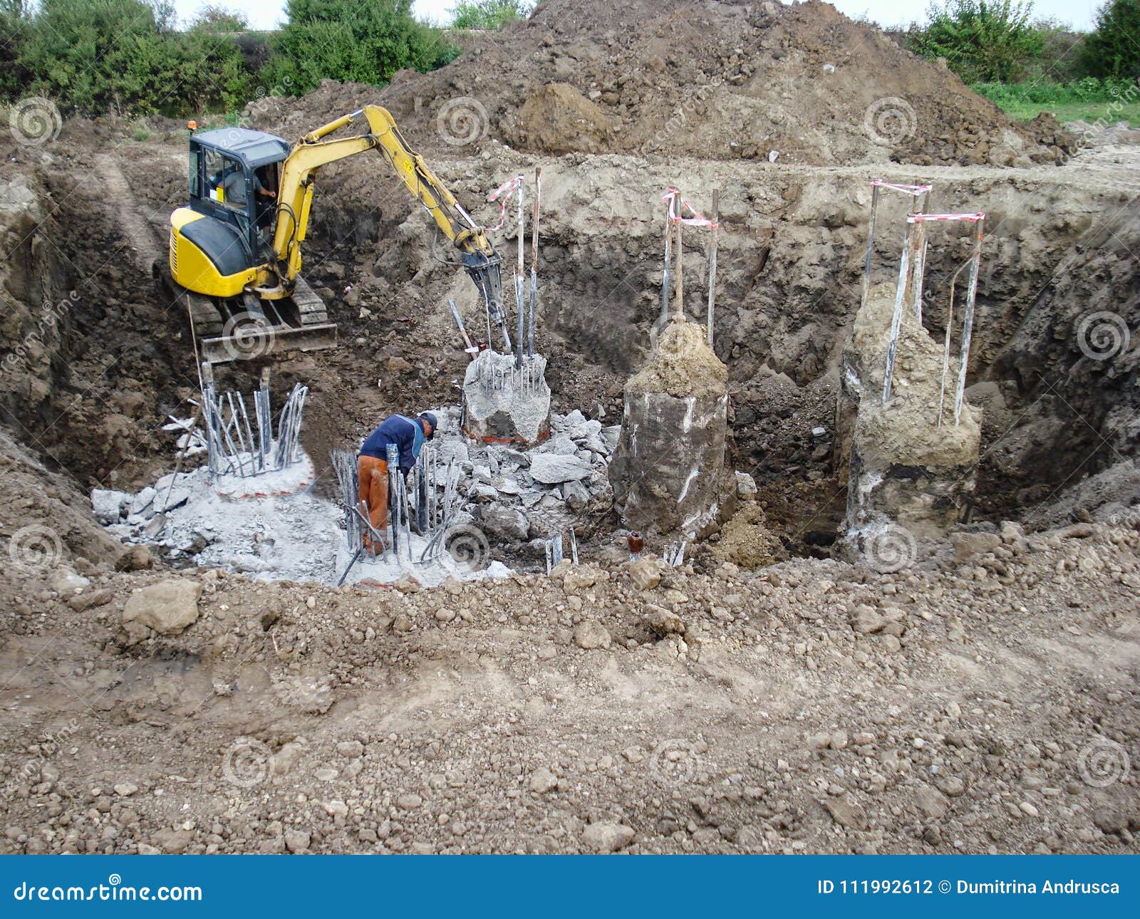 Mini excavator and worker editorial photography. Image of machine ...