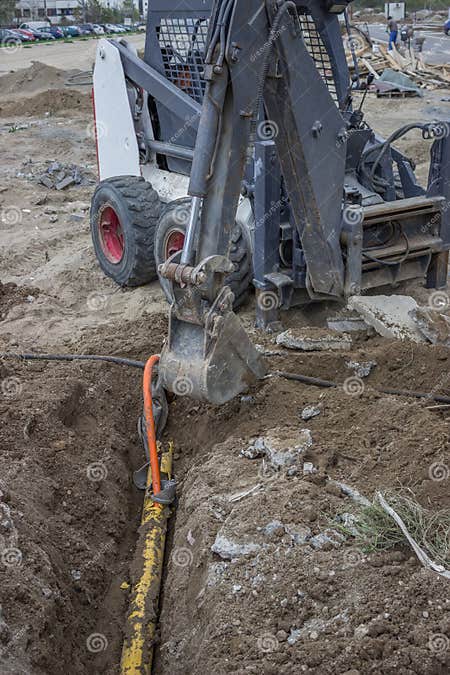 Mini Excavator Digging Up a Electrical Cables from Trench Stock Photo ...
