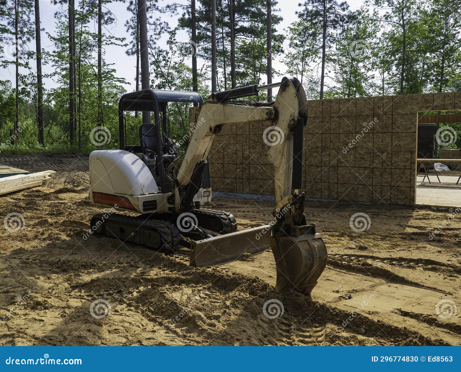 Mini Excavator Parked on the Dirt Outside a New Home Building Project ...