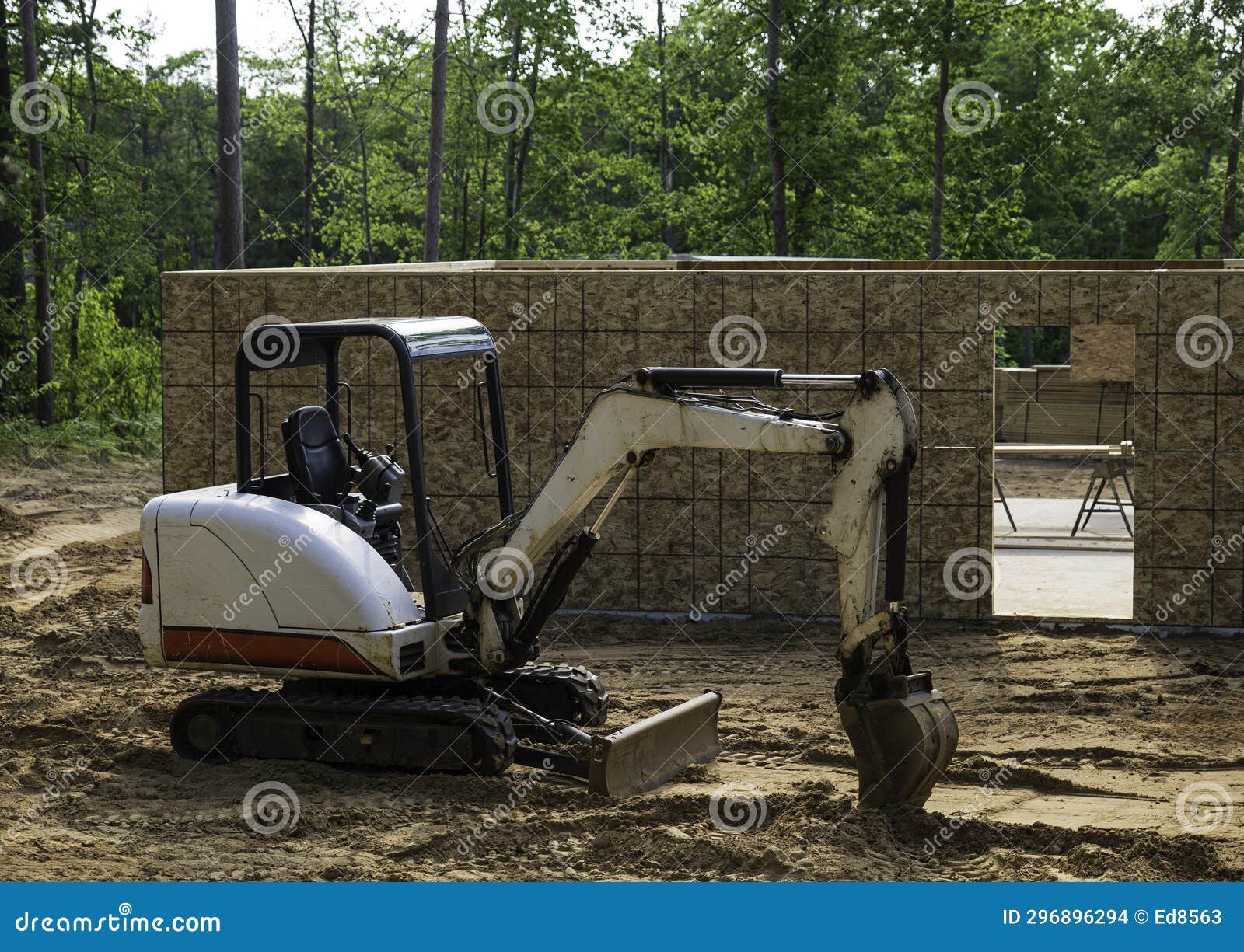 Mini Excavator Parked on the Dirt Outside a New Home Building Project ...