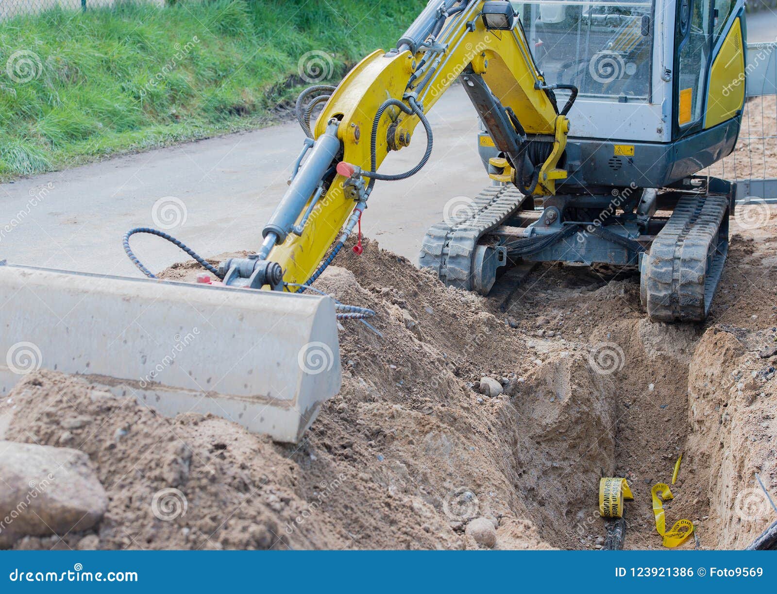 Mini Excavator Digging A Trench Among The Trees For Repairing City ...