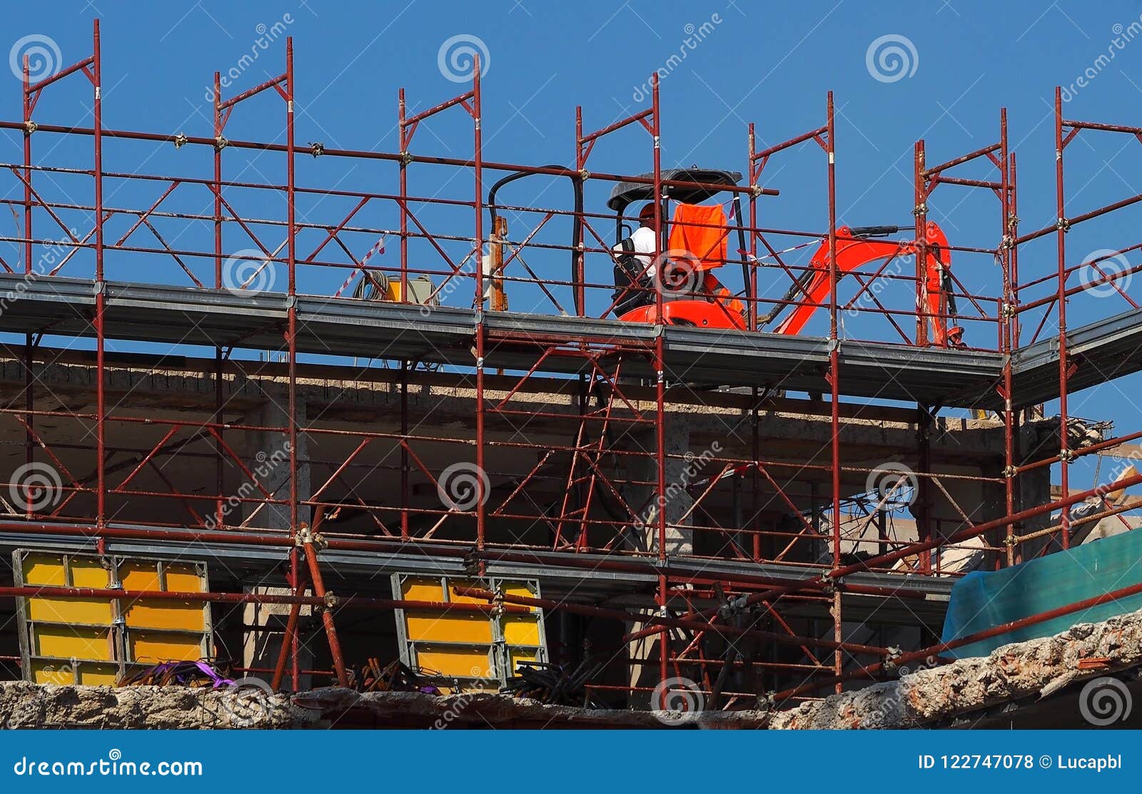Mini Excavator at Work in the Last Floor of a Building Under ...