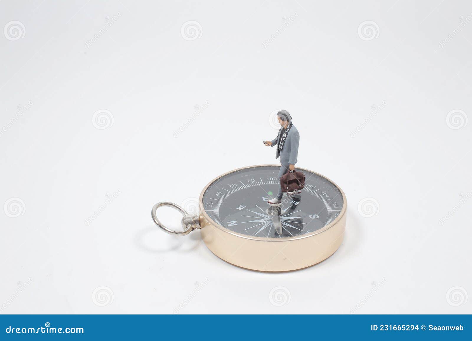 A Mini Figure Business Man Standing on Compass in the Center Stock ...
