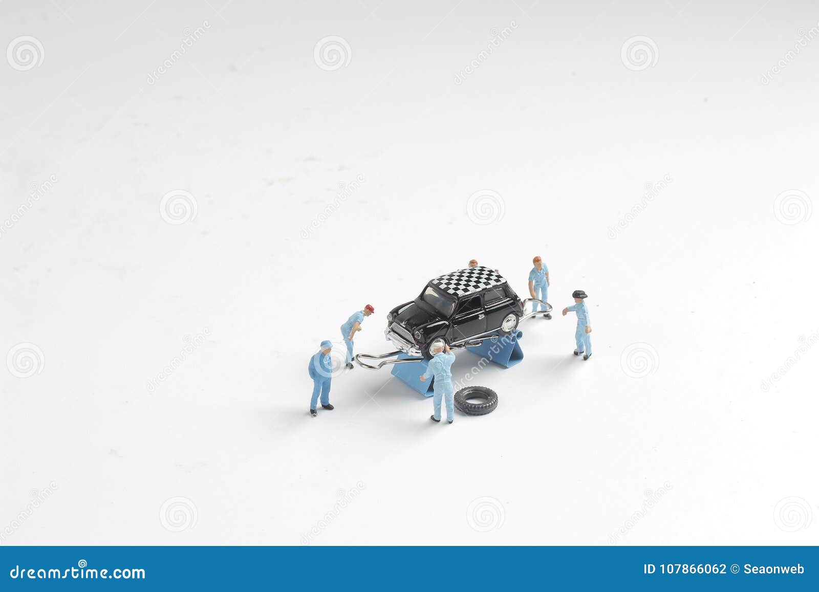 Mini Figure Mechanics Working on a Car Stock Photo - Image of manual ...