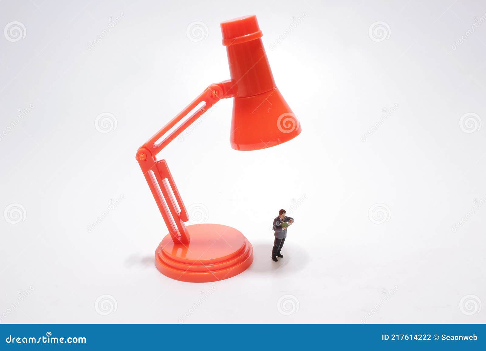 A Mini Figure is Reading a Book with Lamp Stock Photo - Image of ...