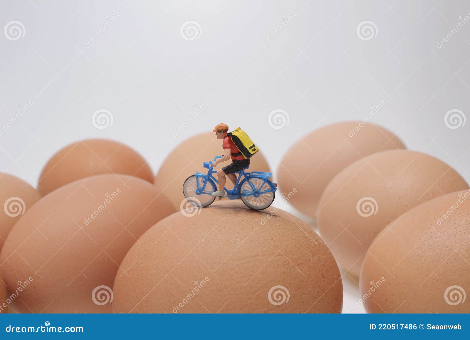 A Mini Figure Ride the Bike on the Eggs Stock Photo - Image of safety ...