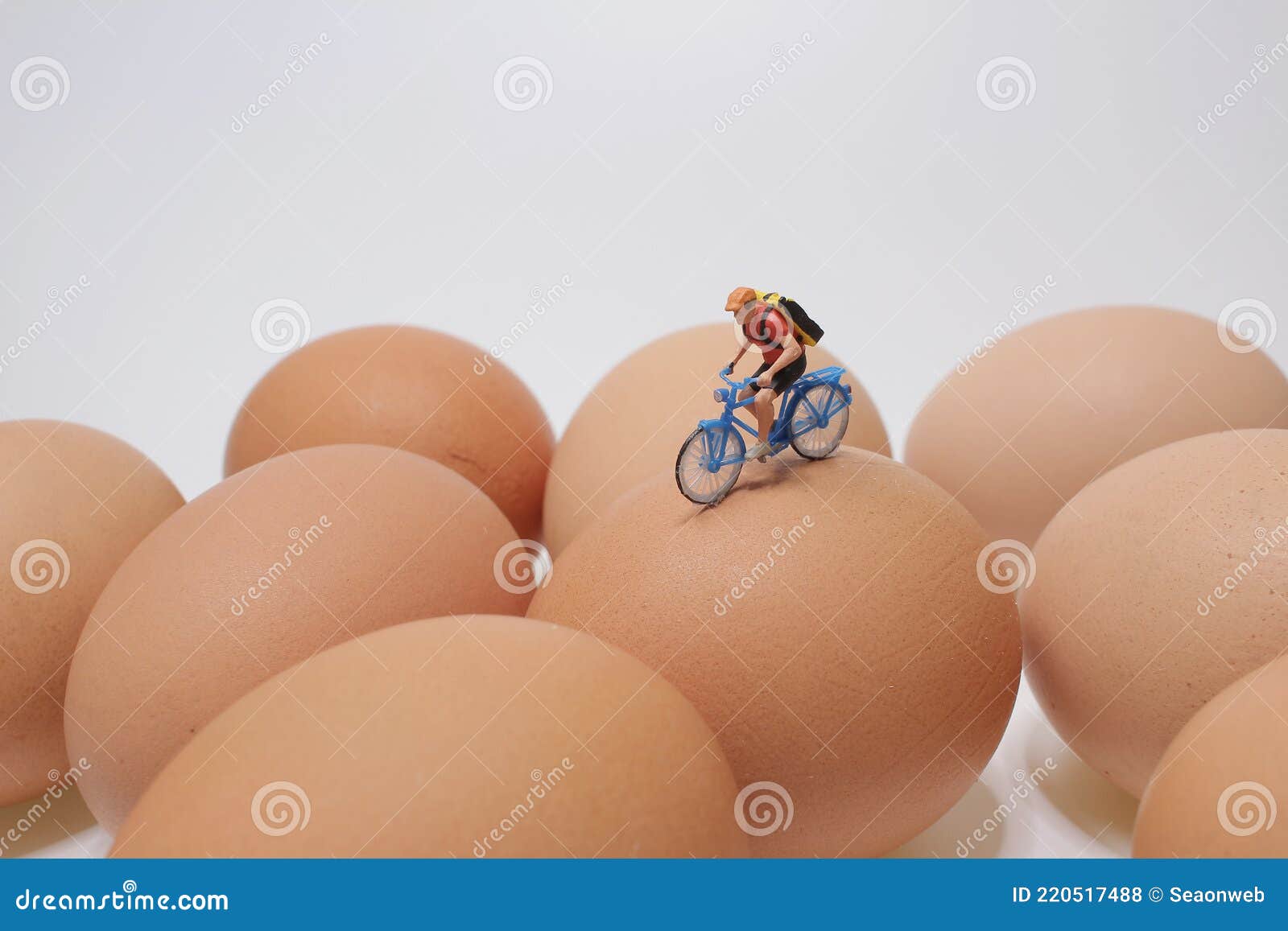 A Mini Figure Ride the Bike on the Eggs Stock Photo - Image of race ...