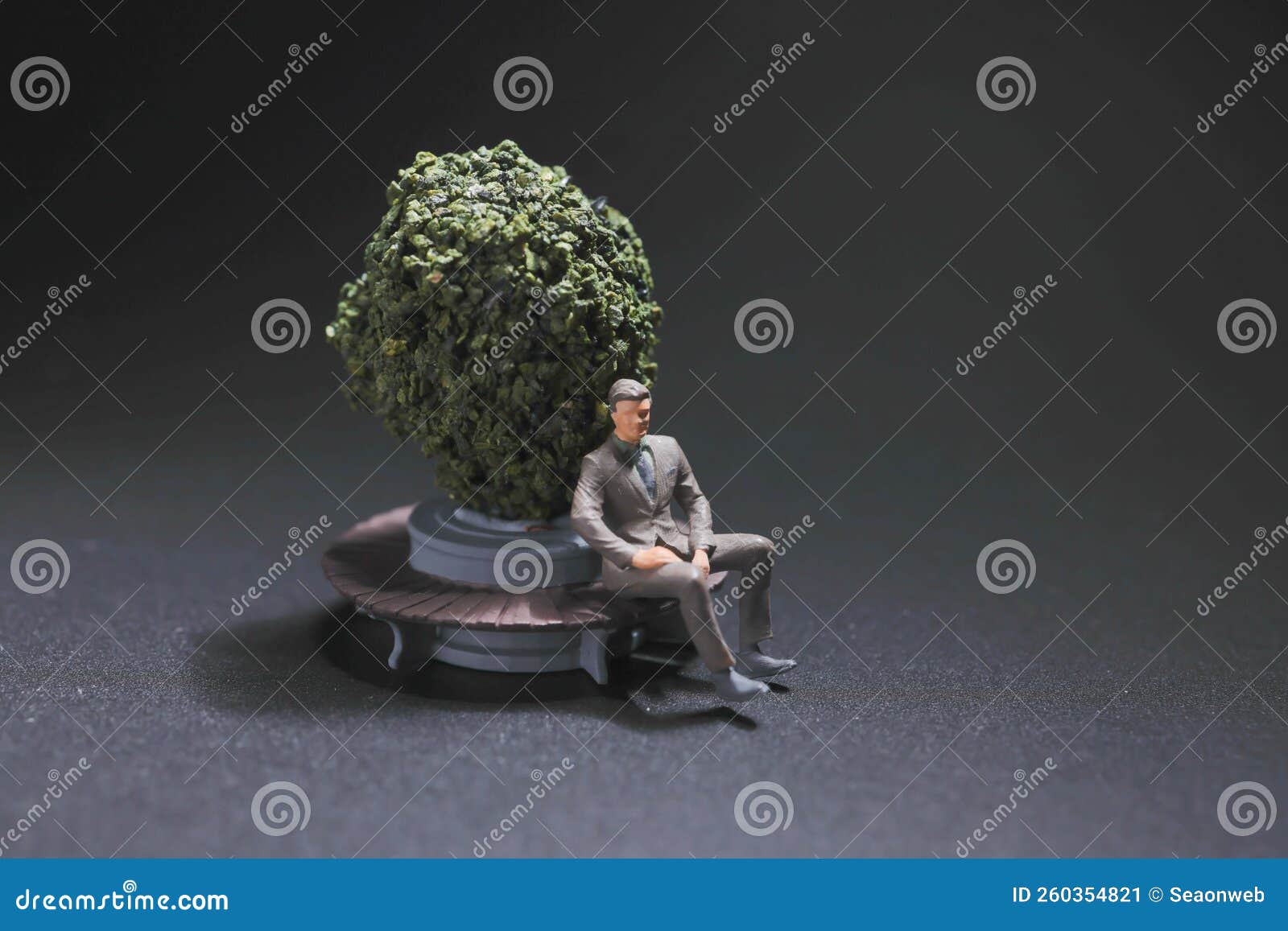 A Mini of Figure Sit on the Park Bench Stock Image - Image of laptop ...