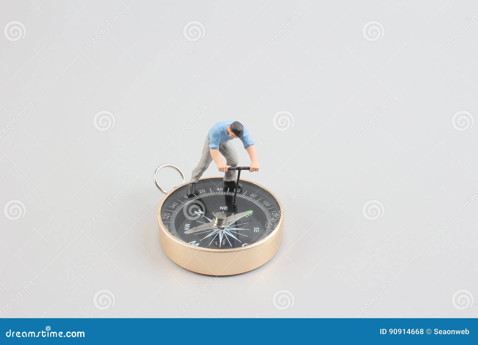 Mini Figure Standing on a Compass Stock Photo - Image of travelers ...