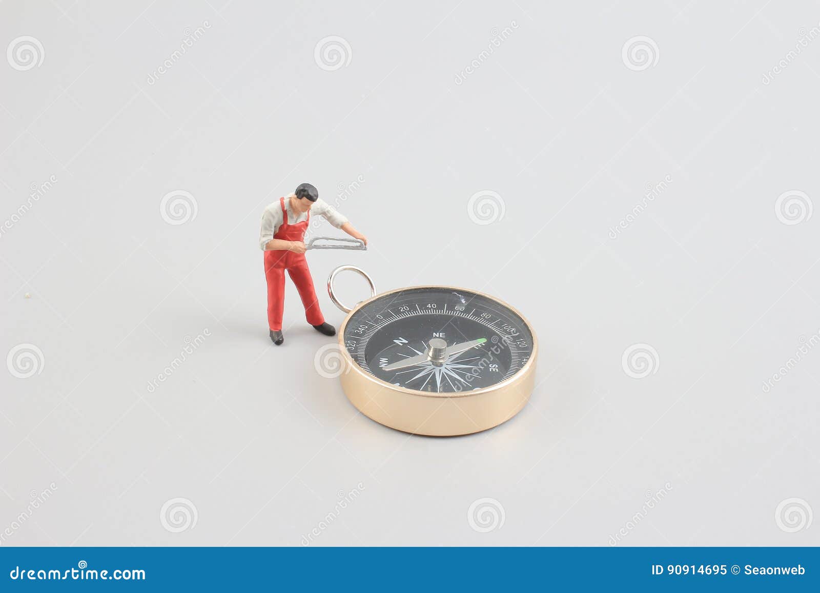 Mini Figure Standing on a Compass Stock Image - Image of executives ...