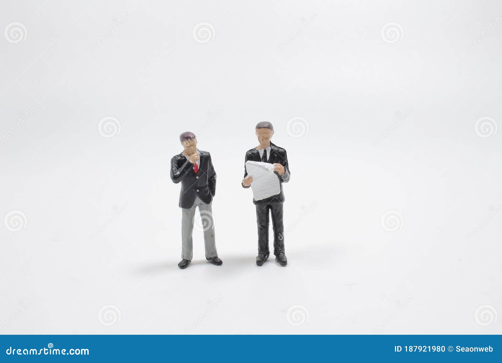 A Mini Figure Standing and Reading Newspaper Stock Photo - Image of ...