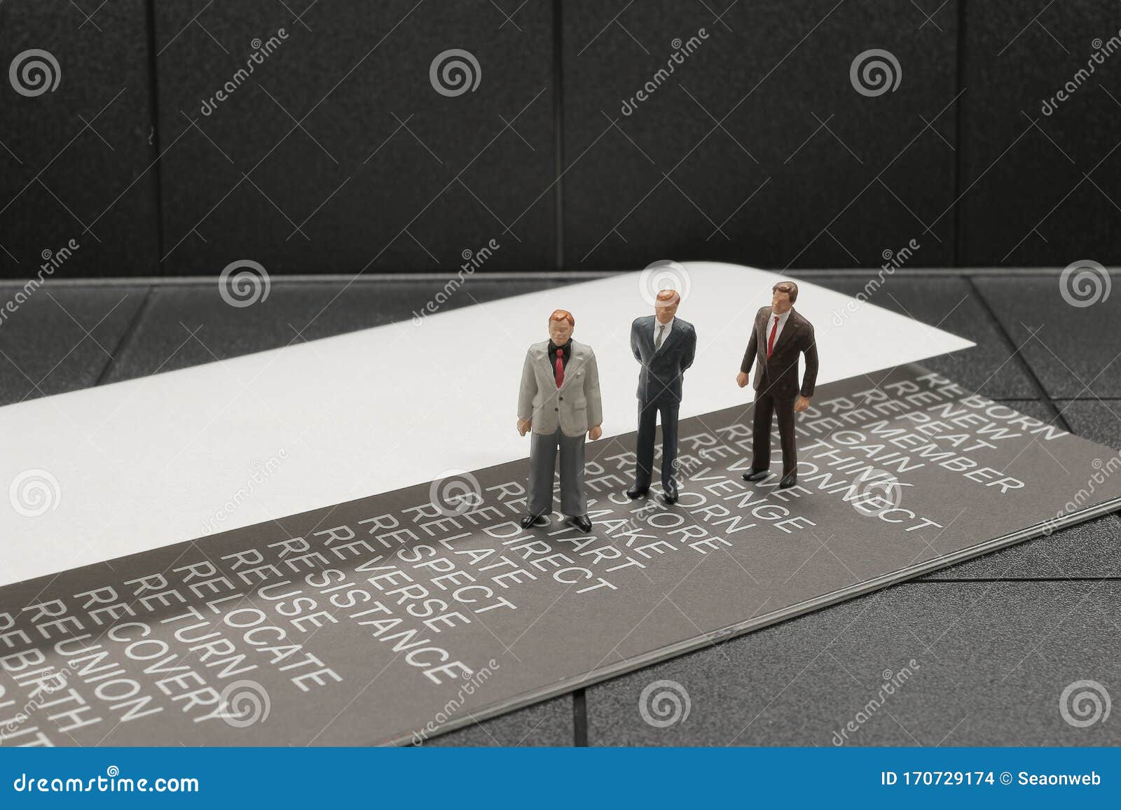 A Mini Figure Standing and Walking on Text Paper Stock Photo - Image of ...