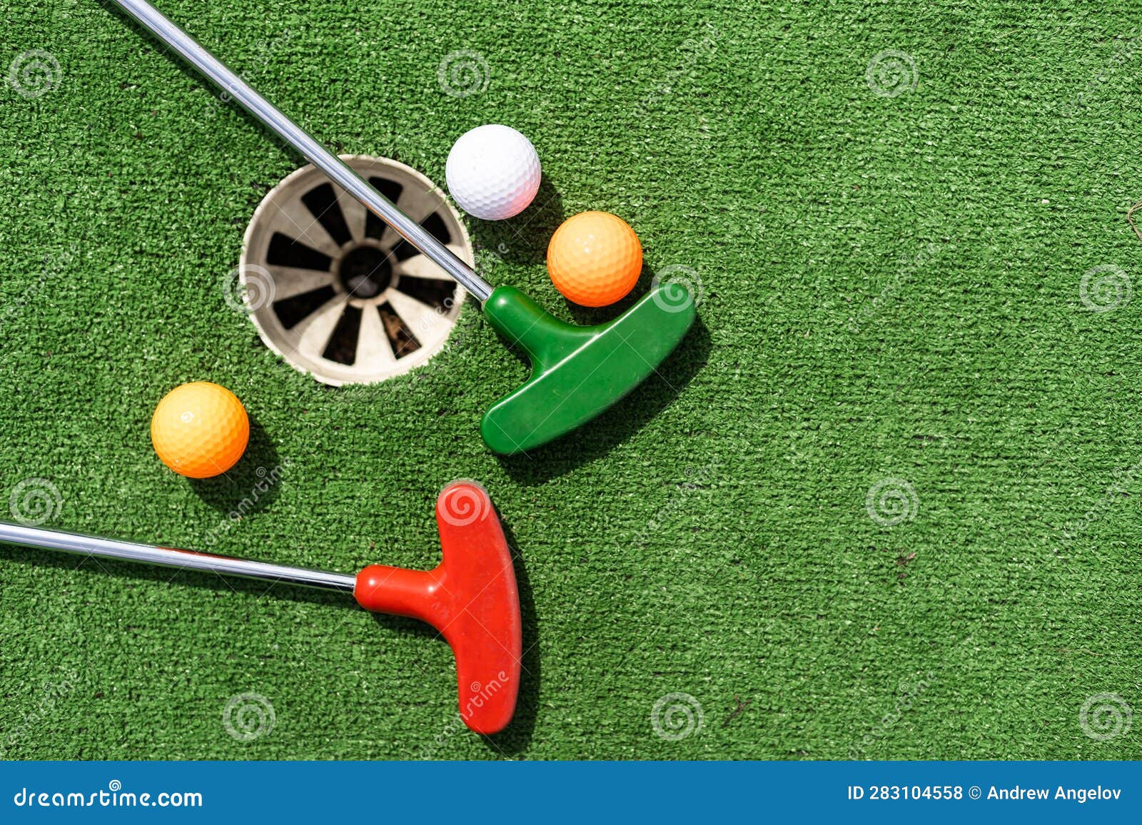 Mini-golf Clubs and Balls of Different Colors Laid on Artificial Grass ...