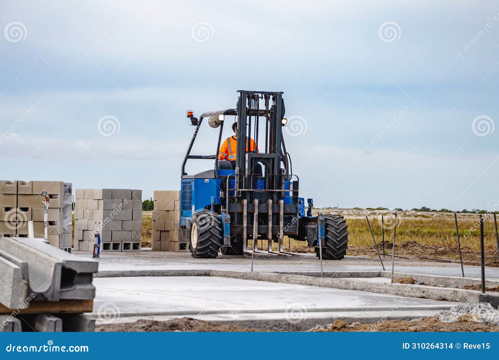 Mini Grader, Leaving Cinder Blocks, at Concrete Slab Stock Photo ...