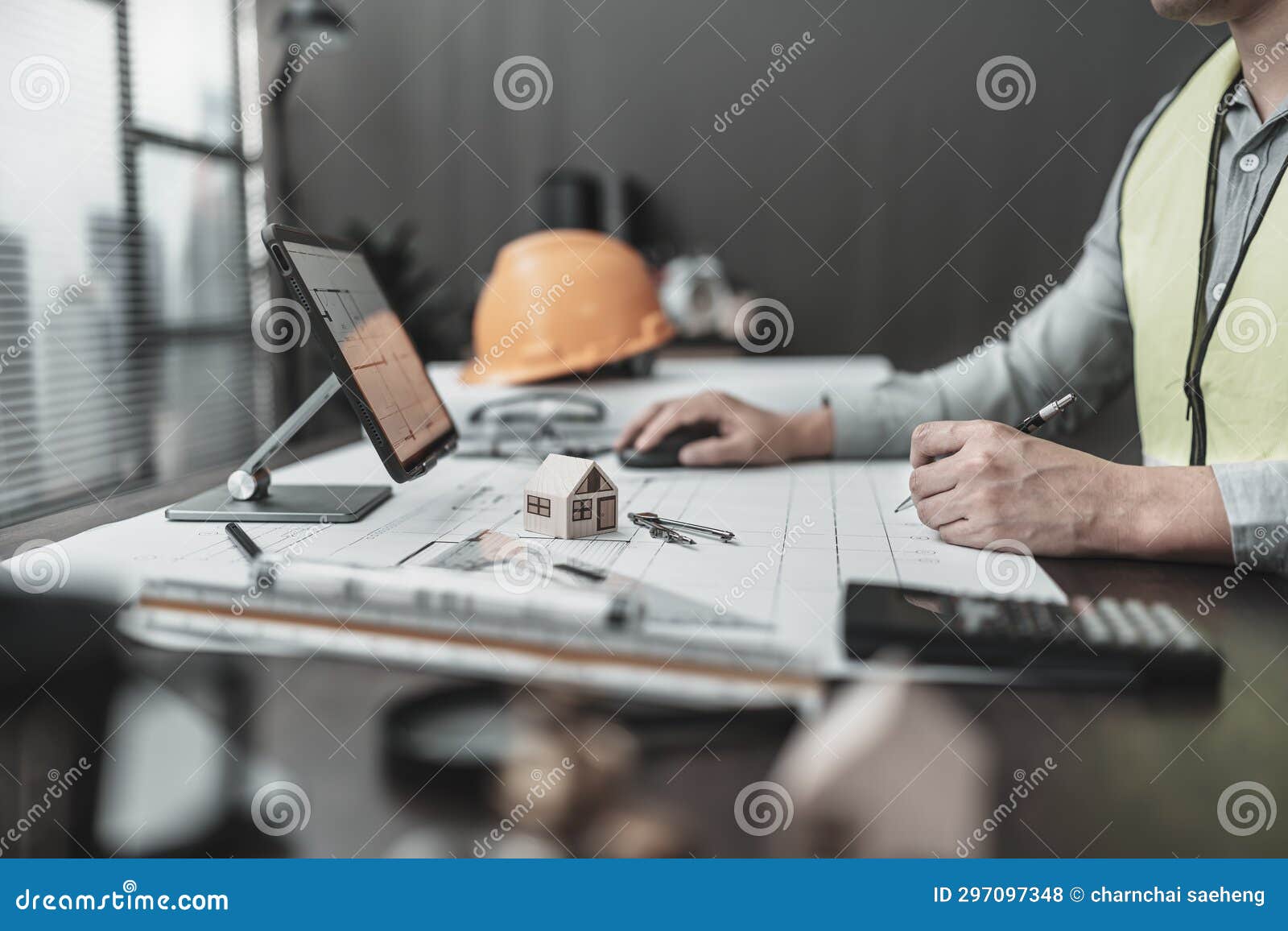 Mini House Model in Front of Architect Engineer Working on Blueprint ...
