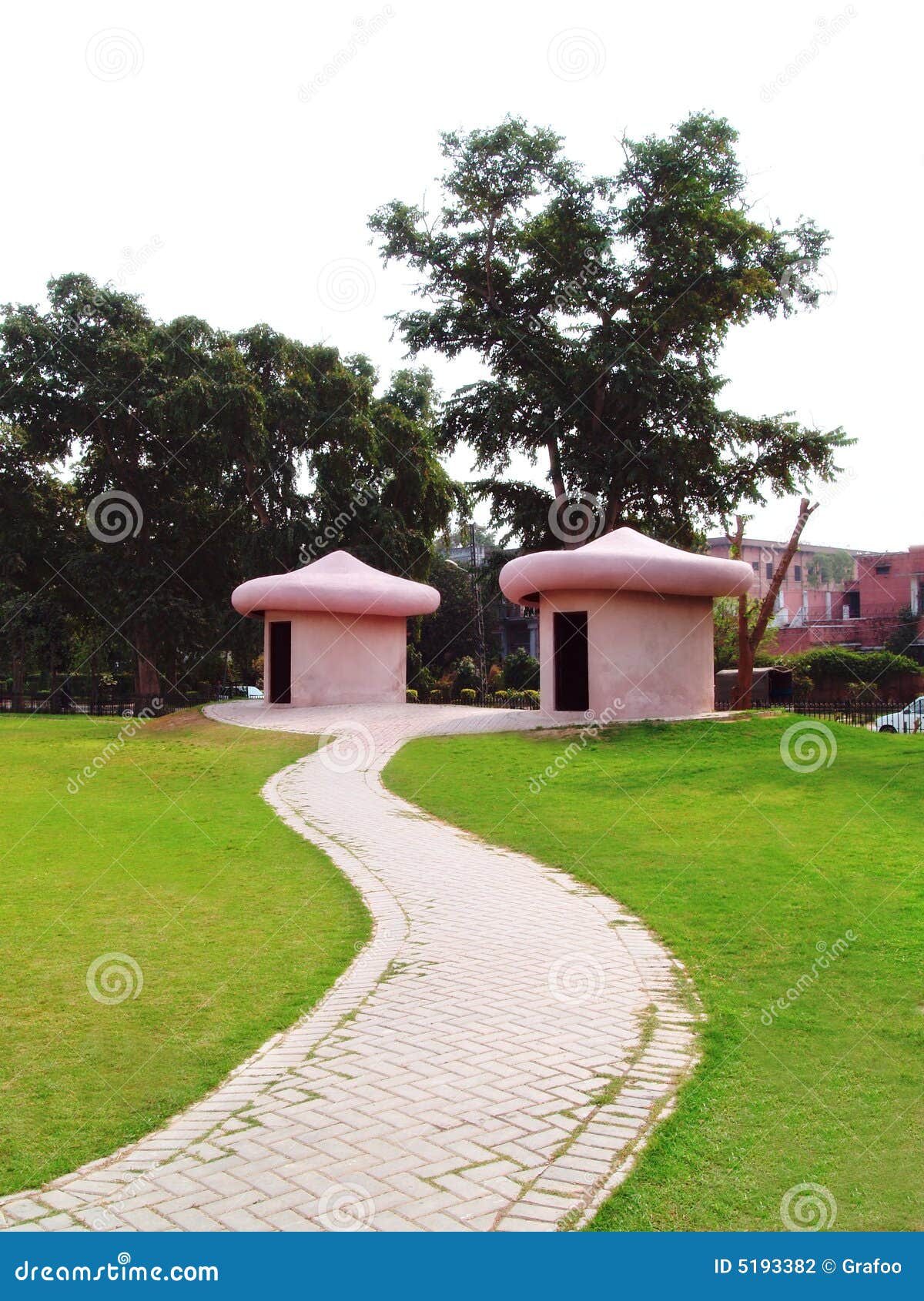 Mini Huts at the End of a Path Stock Photo - Image of lawn, buildings ...