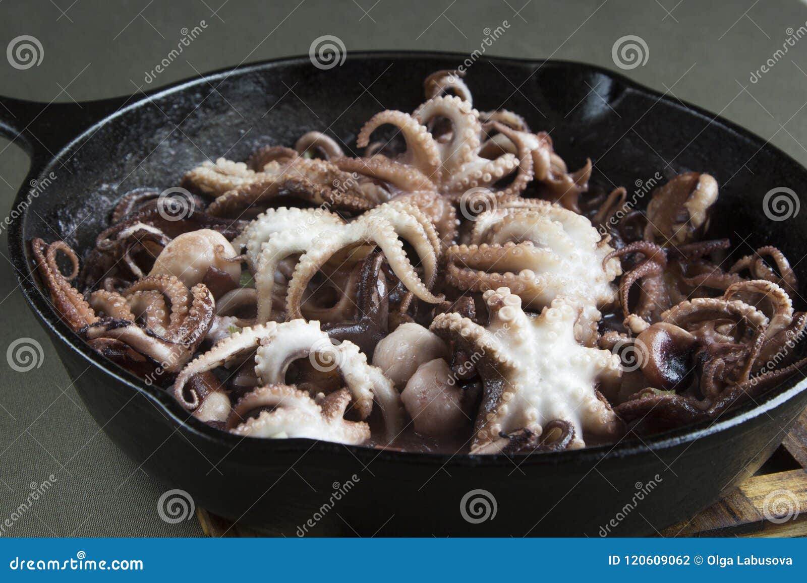 Mini Octopus In The Process Of Roasting On A Cast Iron Pan Royalty-Free ...