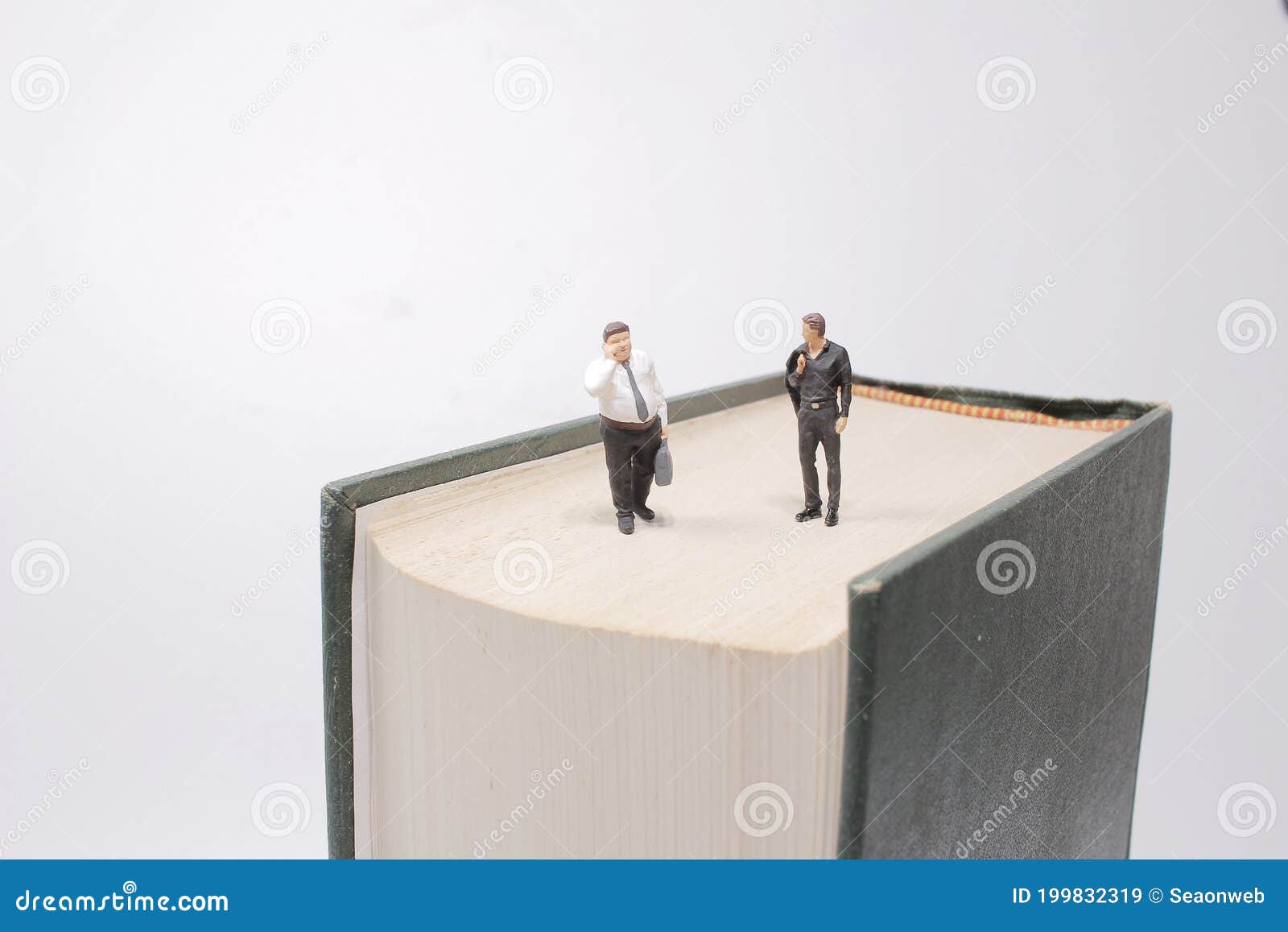 A Mini People Small Figure Businessman Standing on Book Stock Image ...