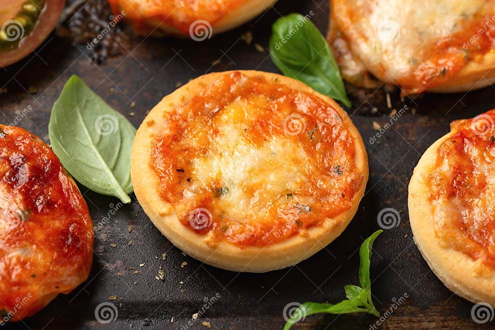 Mini Pizzas with Tomatoes and Mozzarella Cheese Stock Photo - Image of ...