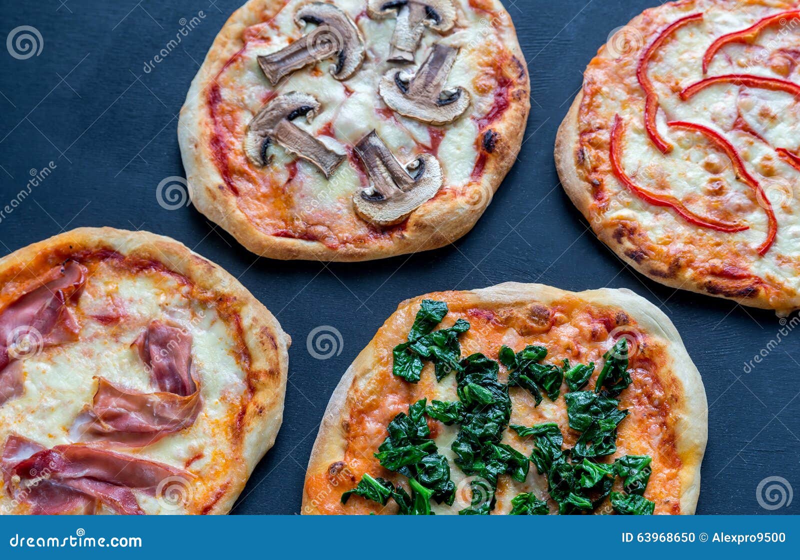 Mini Pizzas with Various Toppings on the Wooden Board Stock Photo ...