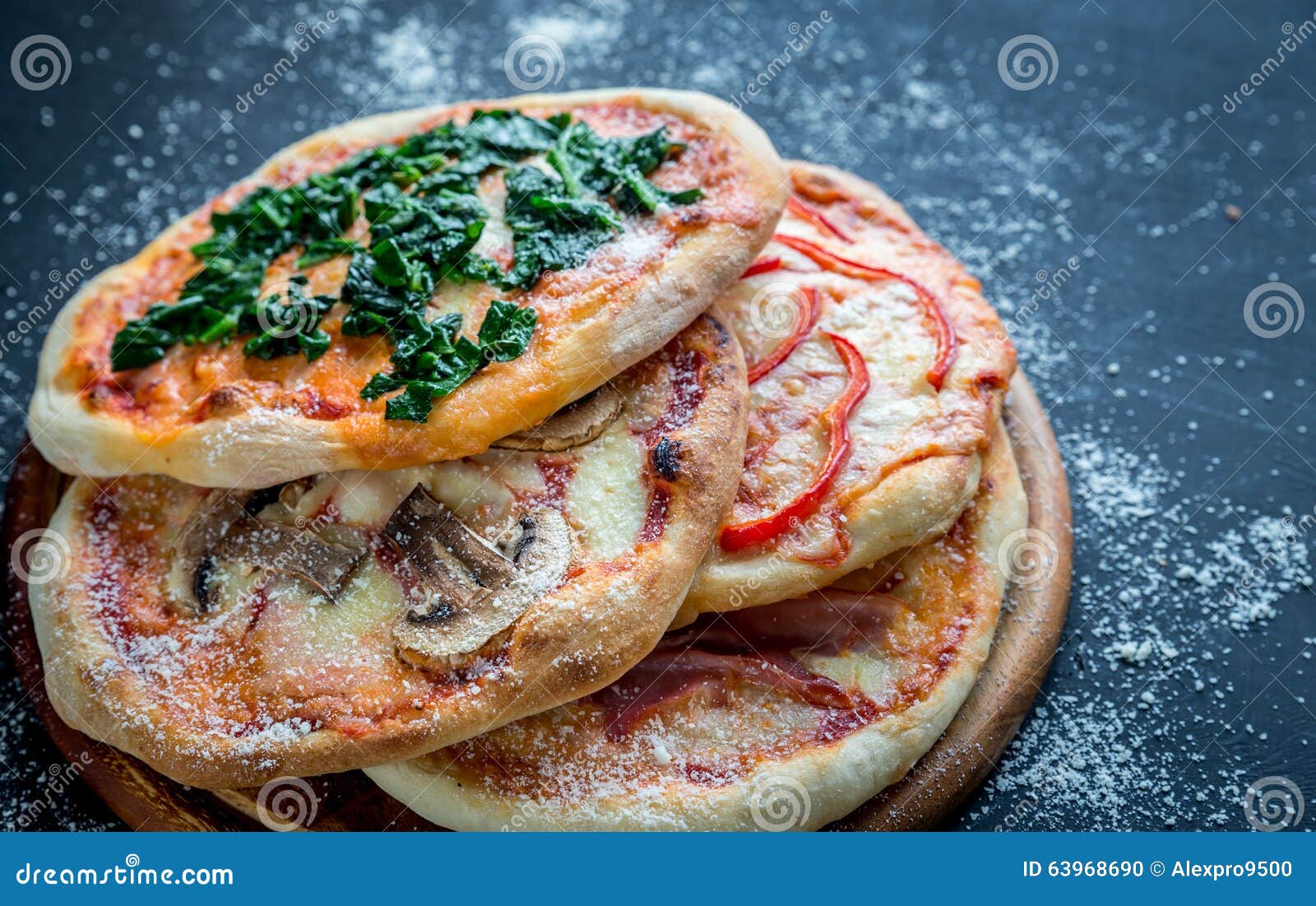 Mini Pizzas with Various Toppings on the Wooden Board Stock Photo ...