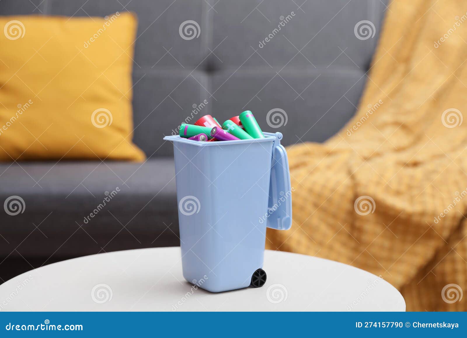 Mini Recycling Bin with Different Types of Batteries on White Table ...