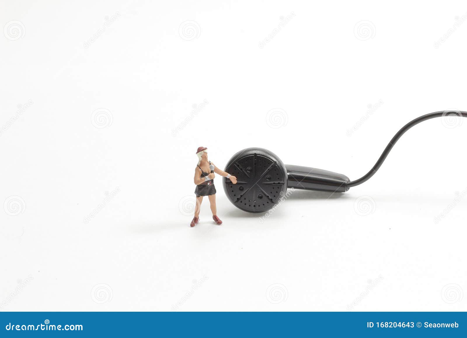Mini Singer and Guitar Player Standing on a Pair of Ear Buds Stock ...