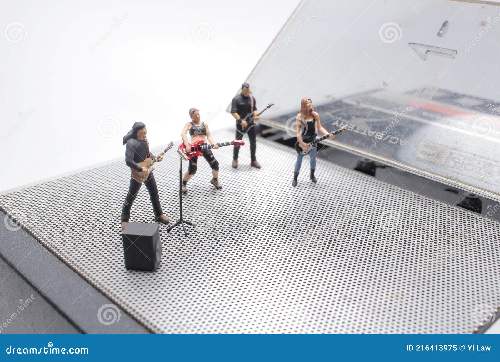 A Mini Singer and Guitar Player Standing on Speaker Stock Image - Image ...