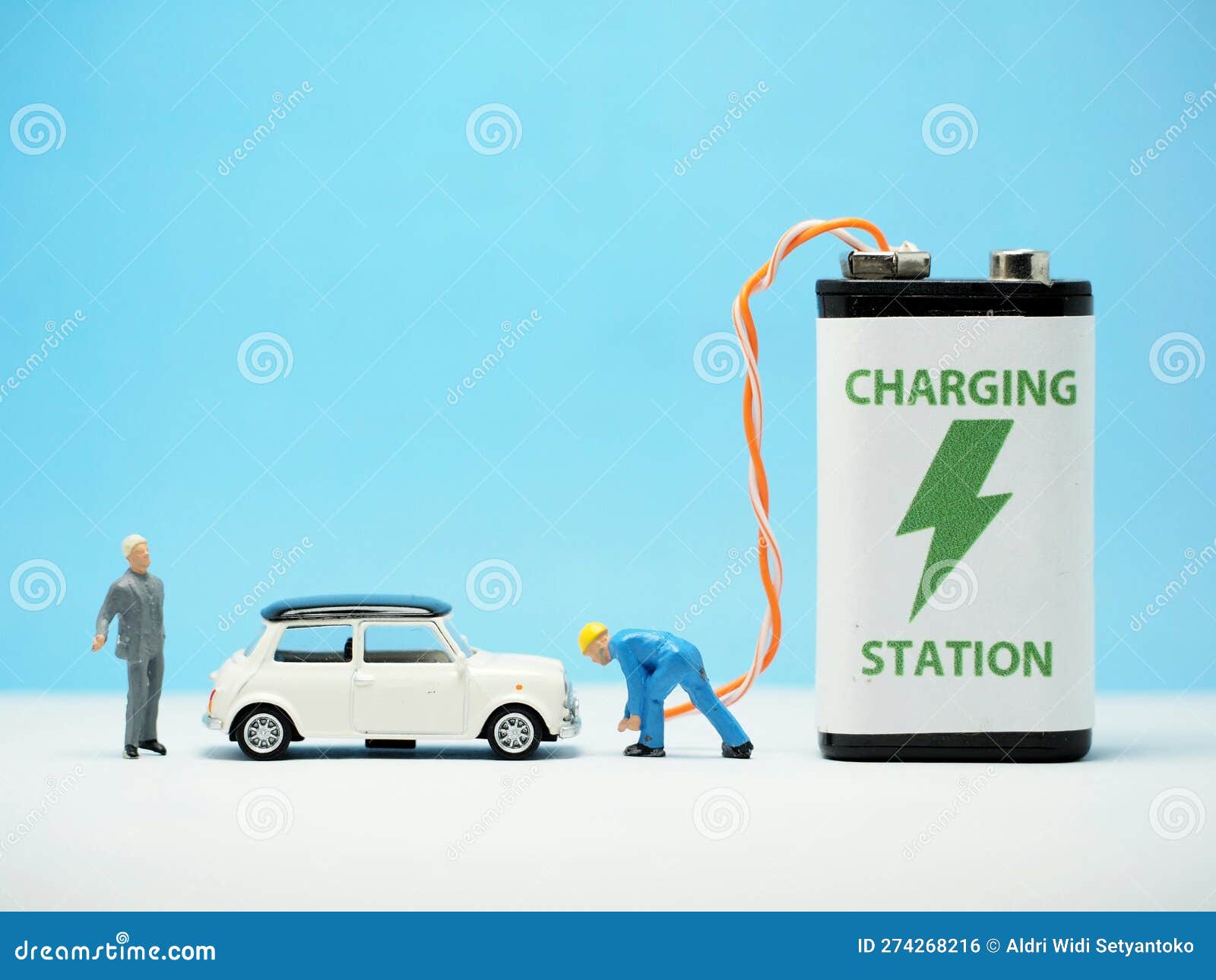 Mini Toy at Table with Blue Background. Electric Vehicle & X28;EV& X29 ...