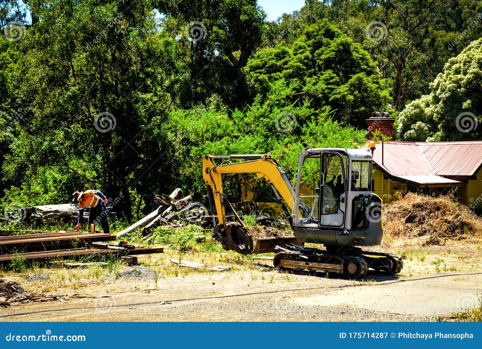 A Mini Yellow Construction Loader Machine with Workers at the Railway ...