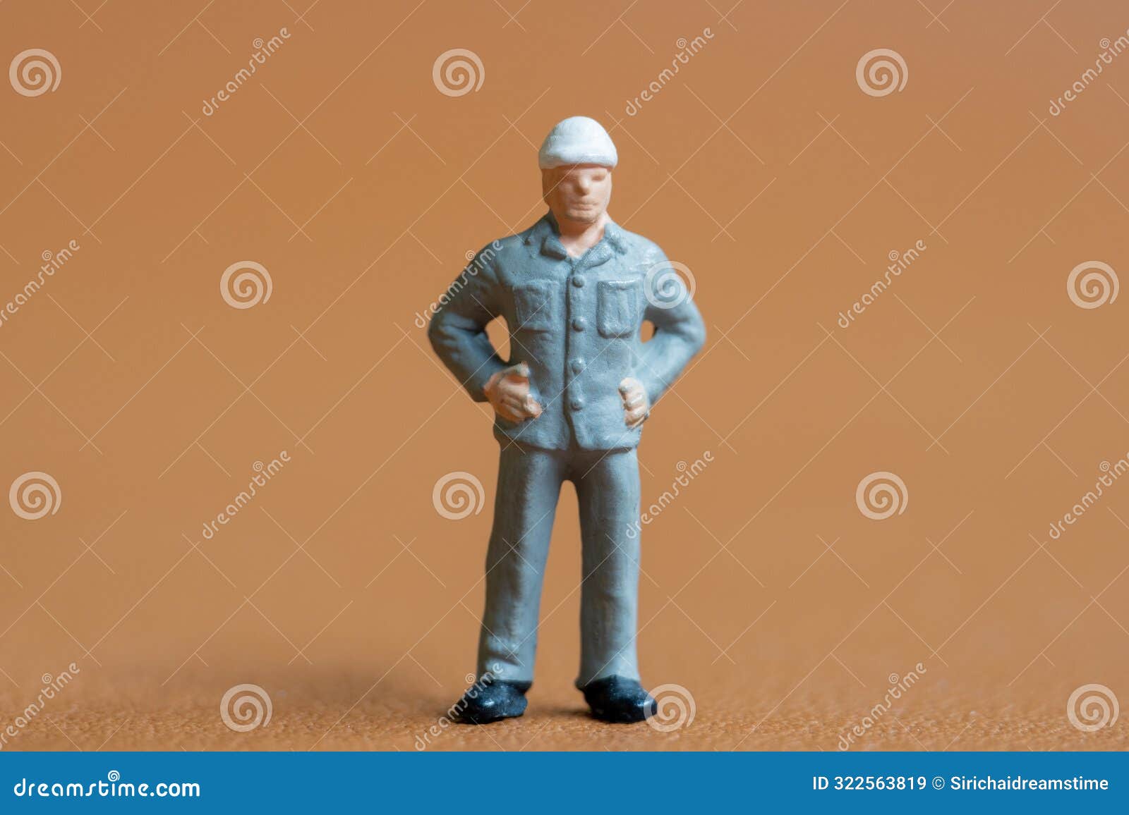 Miniature Construction Worker. a Man Dressed in a Blue Work Uniform ...