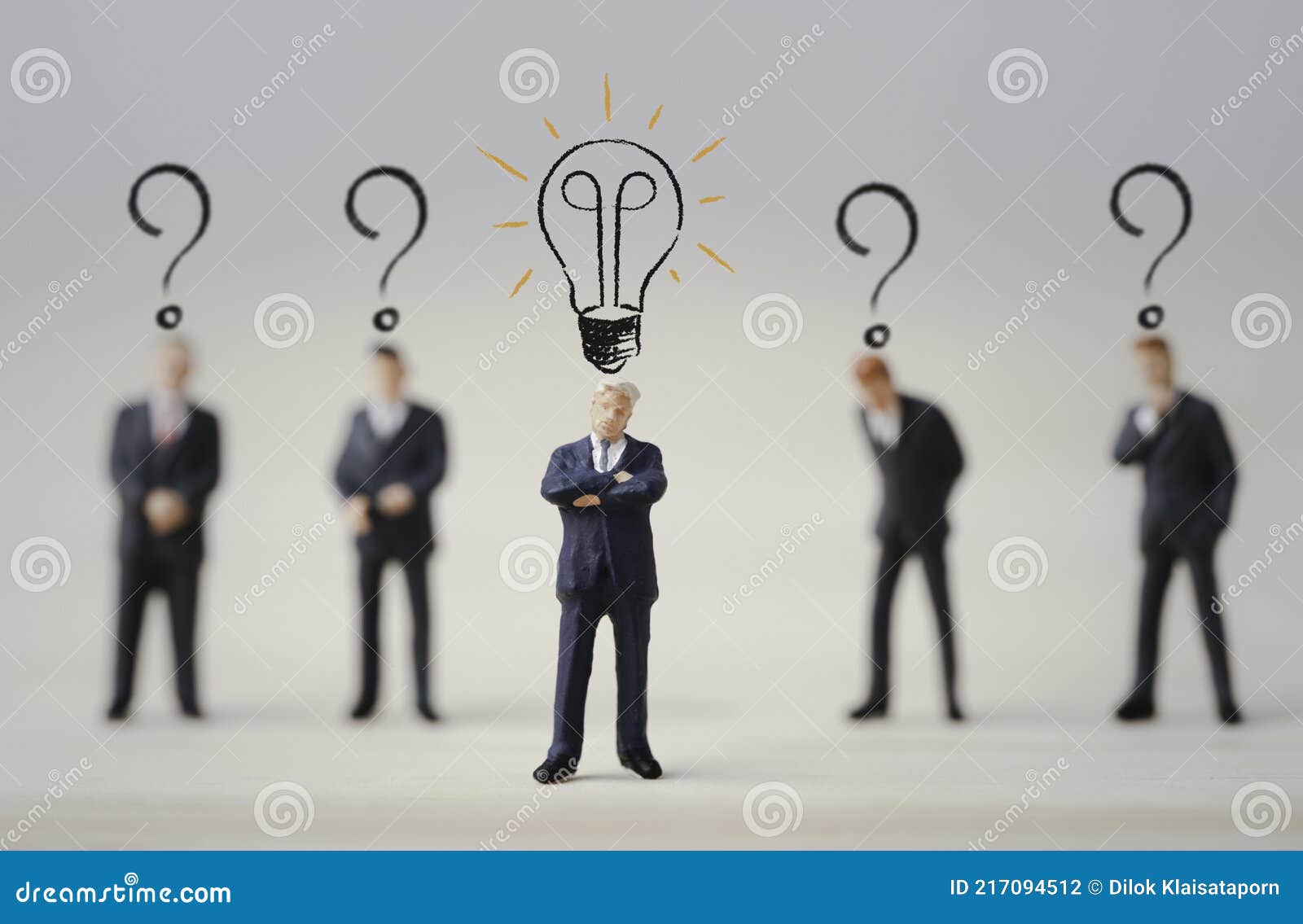 Miniature Figure Businessmen with Glowing Light Bulb and Question Mark ...