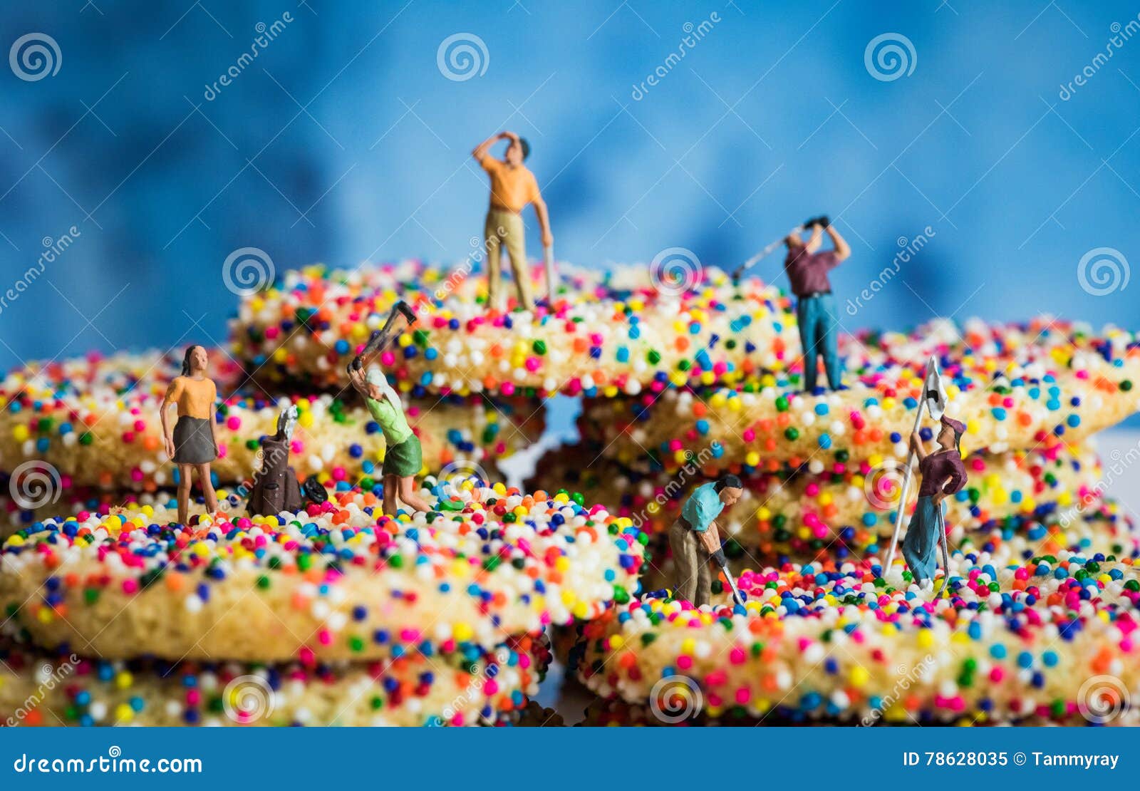 Miniature Figures Golfing on Sprinkle Cookies Stock Image - Image of ...