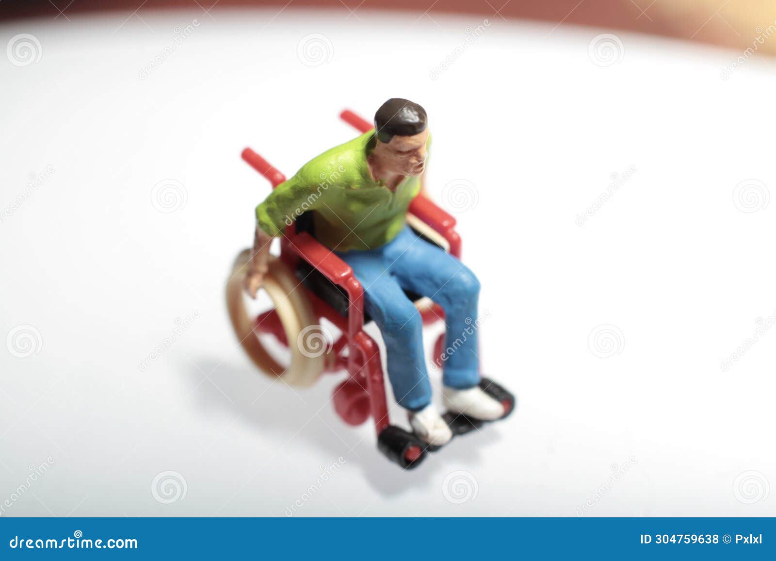 Miniature Figurine of a Disabled Man on a Wheelchair Stock Photo ...