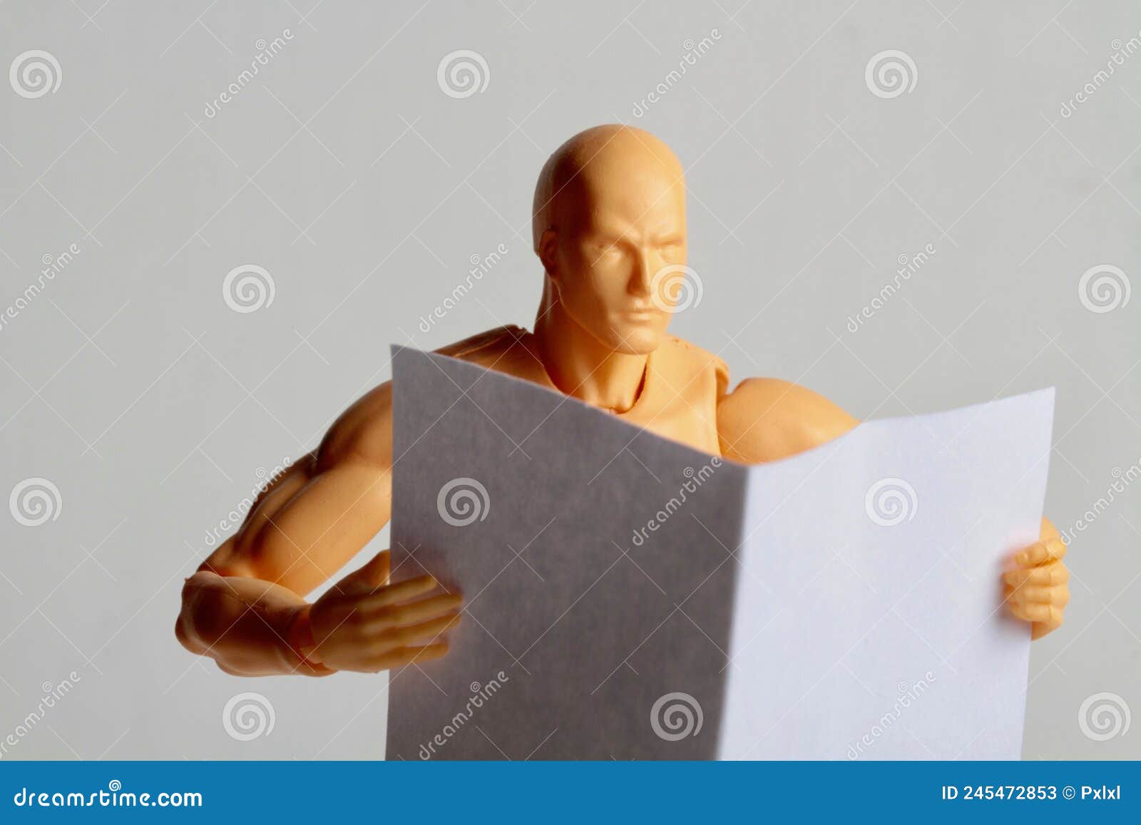 Miniature Figurine of a Man Reading an Empty Paper Sheet Stock Image ...