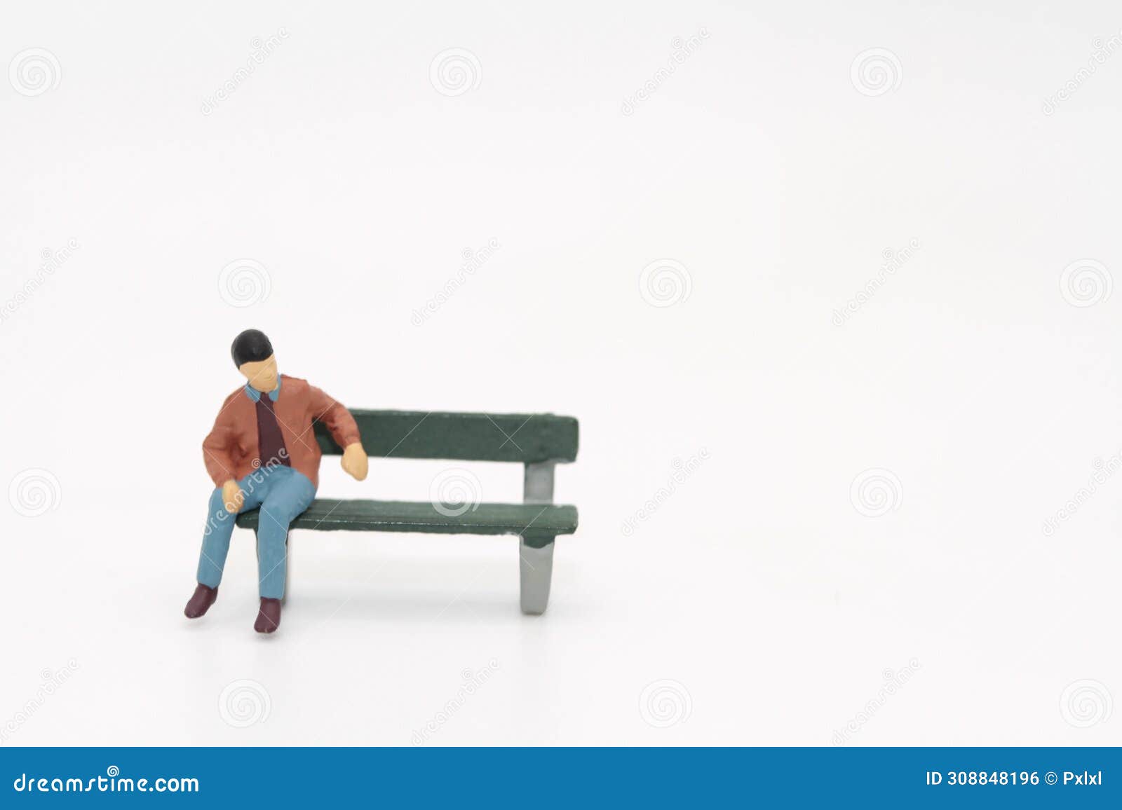 Miniature Figurine of a Man Sitting on a Bench Stock Photo - Image of ...