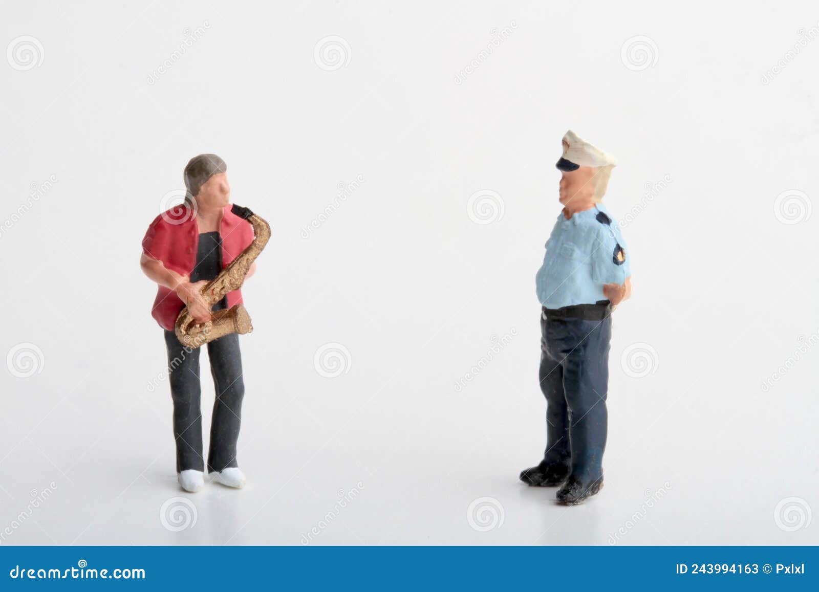 Miniature Figurines of a Policeman with a Saxophone Player Stock Image ...